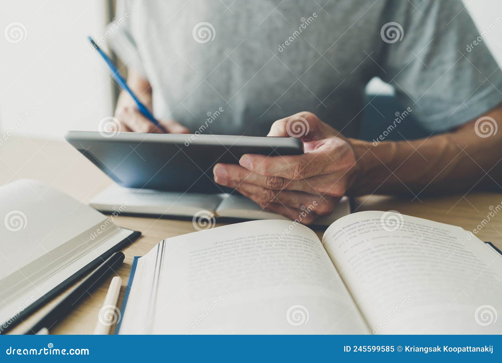 University or College Student Using Tablet for Studying, Learning or ...