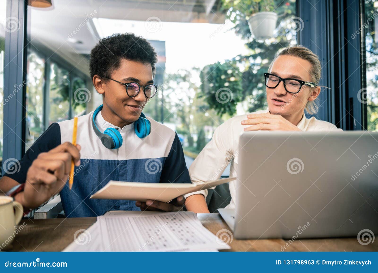 Joyful Positive Man Holding His Notebook in the Hand Stock Image ...