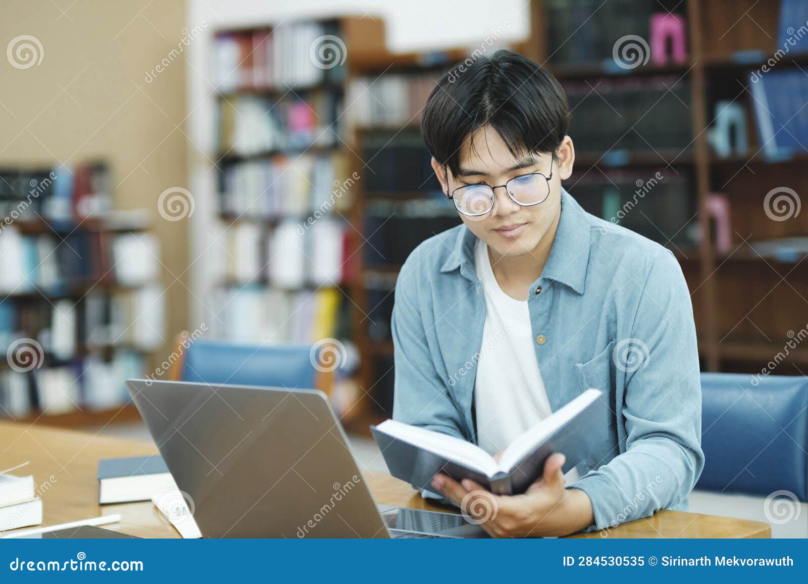 Young University Student Using Laptop for Online Learning, Searching ...