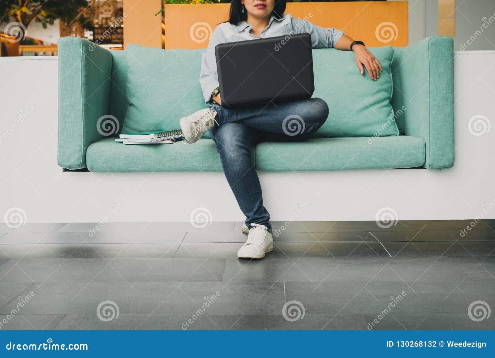 University Student Sitting in Sofa and Using Laptop Computer To Stock ...