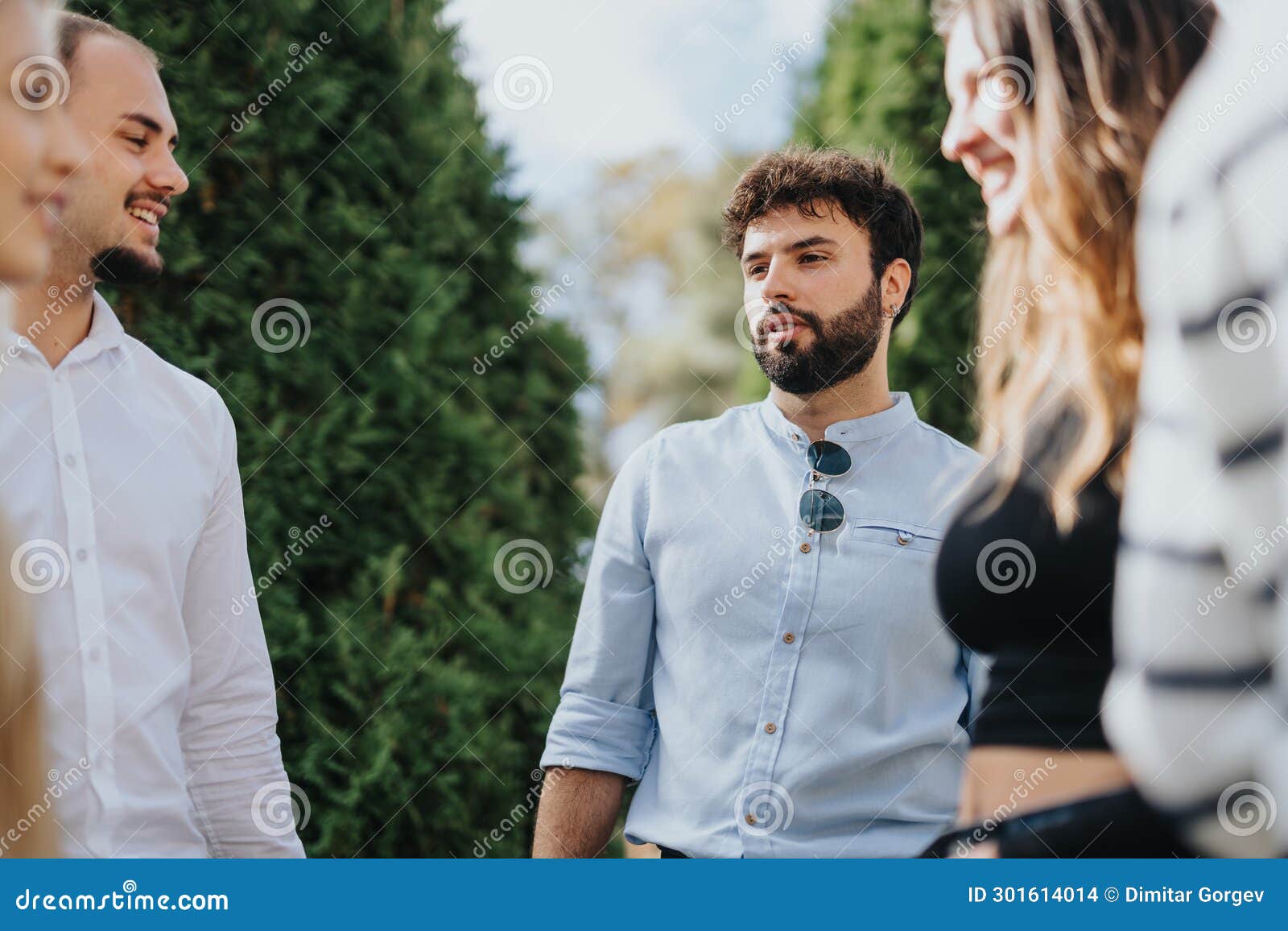 University Students Collaborating on a Faculty Project in a Sunny Park ...