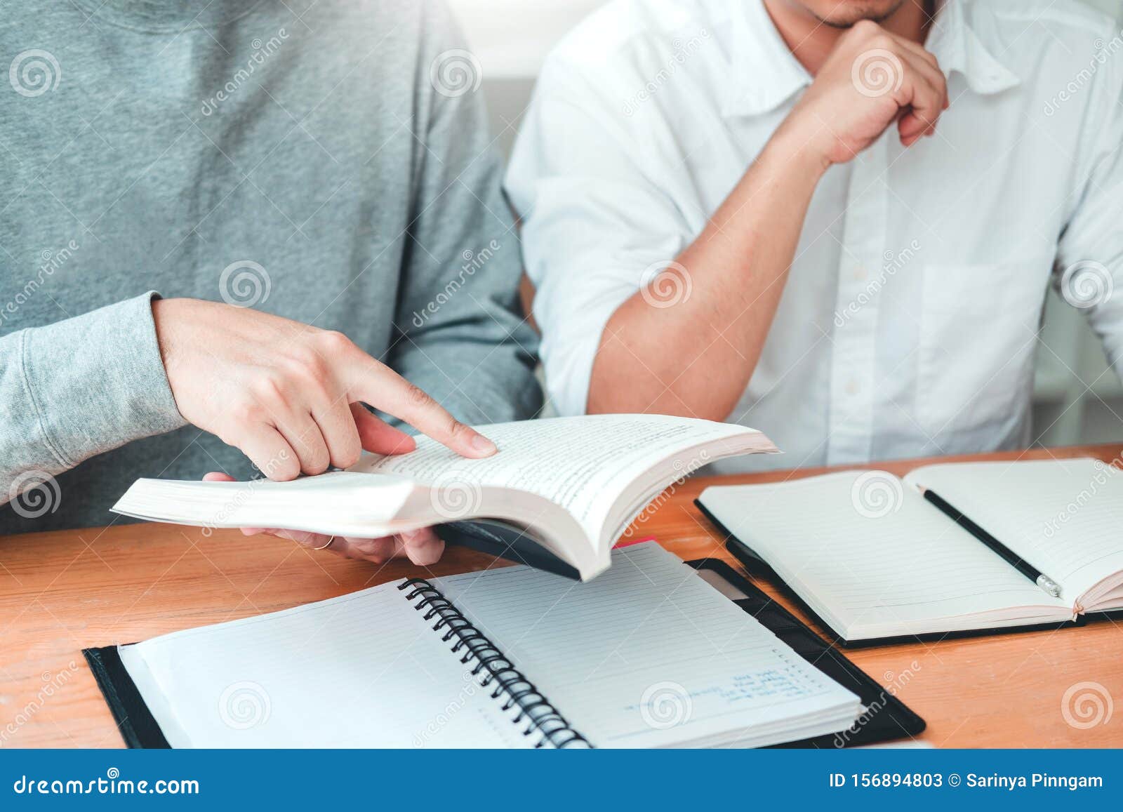 University Students or College Students Studying and Reading Together ...