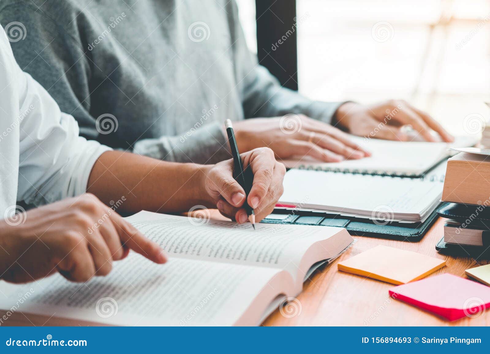 University Students or College Students Studying and Reading Together ...