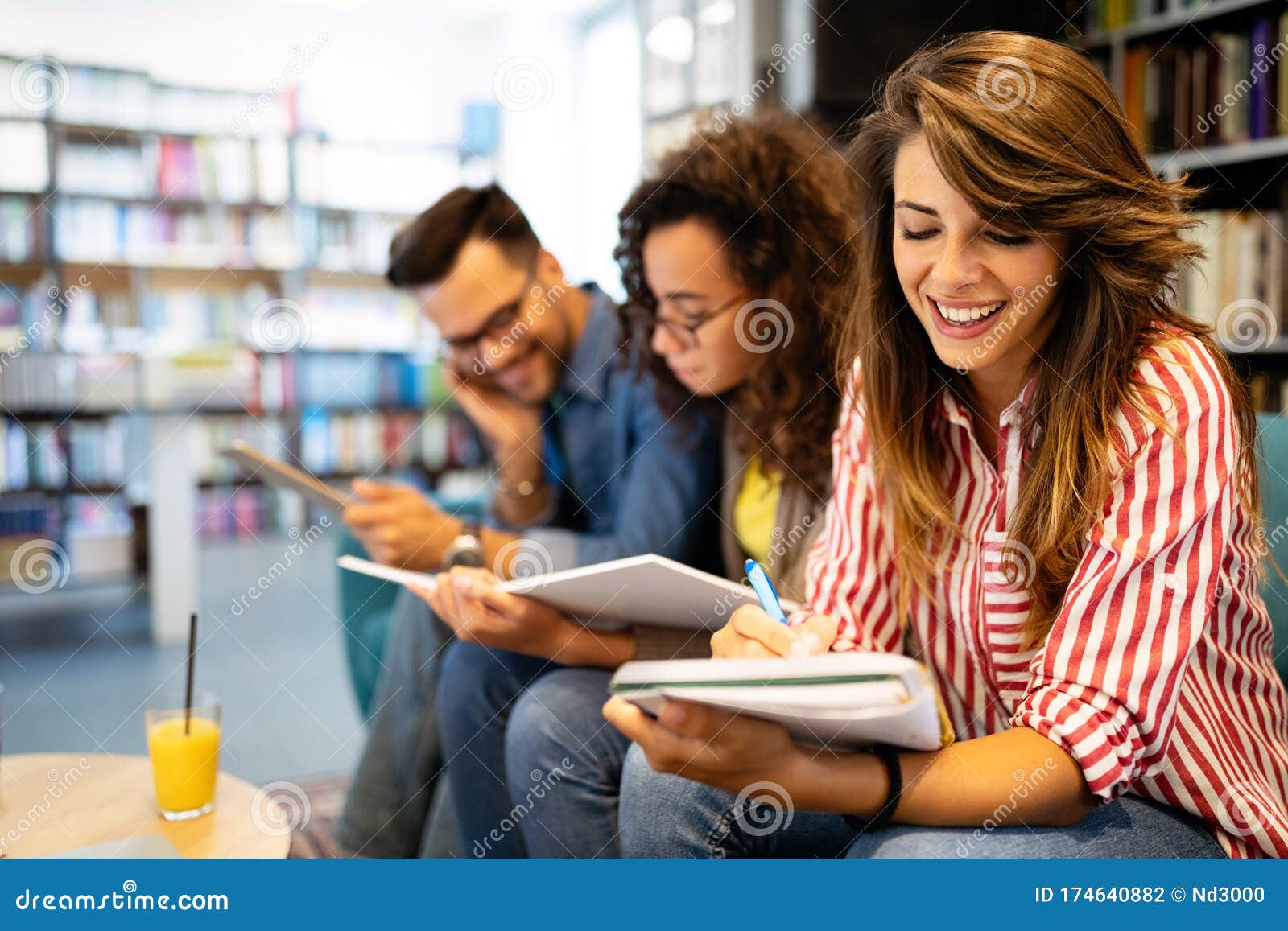University Students in Cooperation at Library. Group of Young Friends ... University Students in Cooperation at Library. Group of Young Friends ...