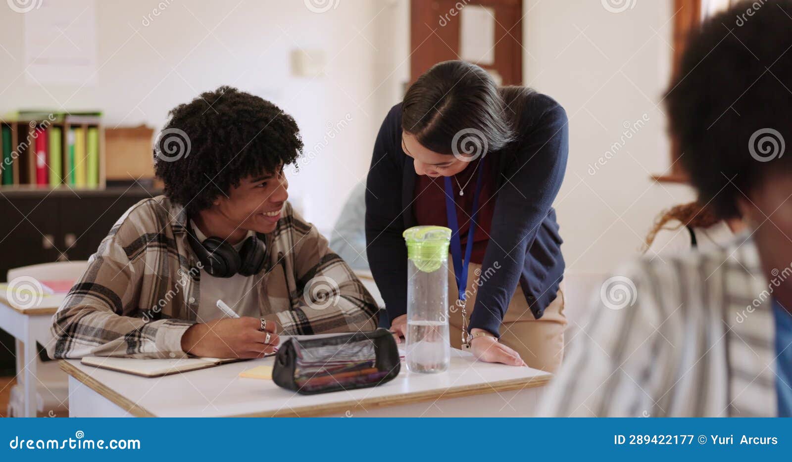 University, Students and Help from Professor in Classroom for Exam in ...