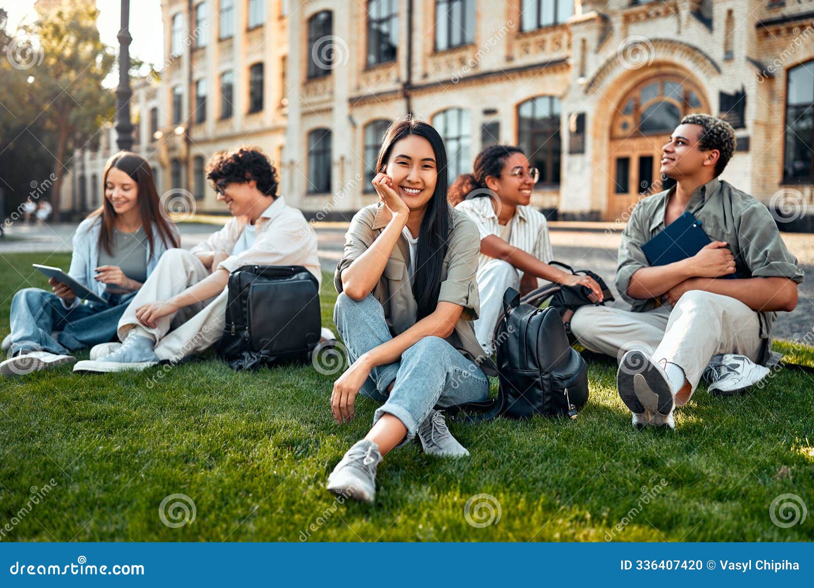 University Students Relax on the Green Grass on the Campus. Stock Photo - Image of female ...