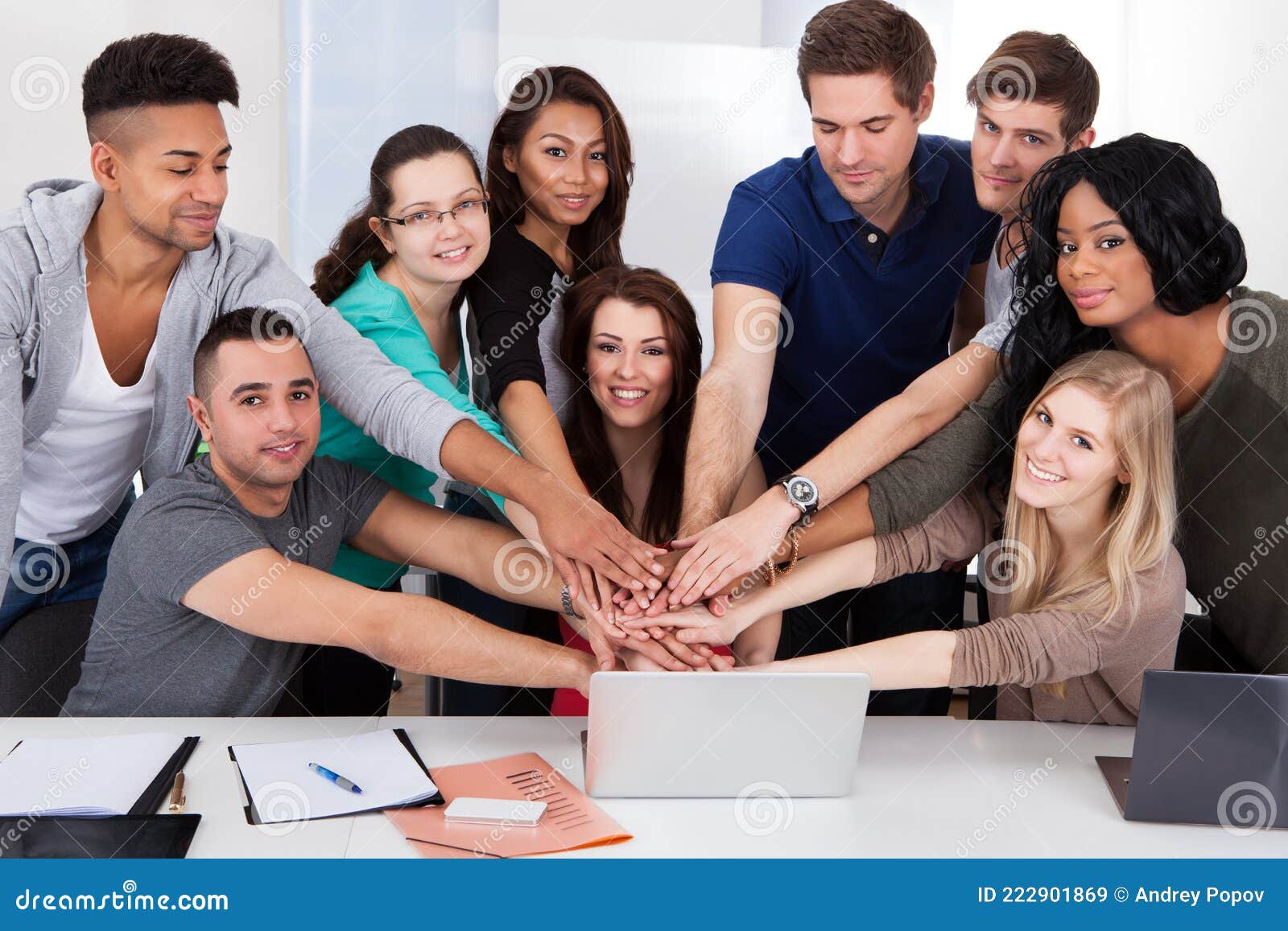 University Students Stacking Hands at Desk Stock Image - Image of ...