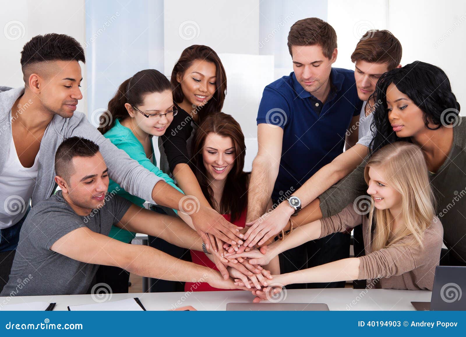 University Students Stacking Hands at Desk Stock Image - Image of adult ...