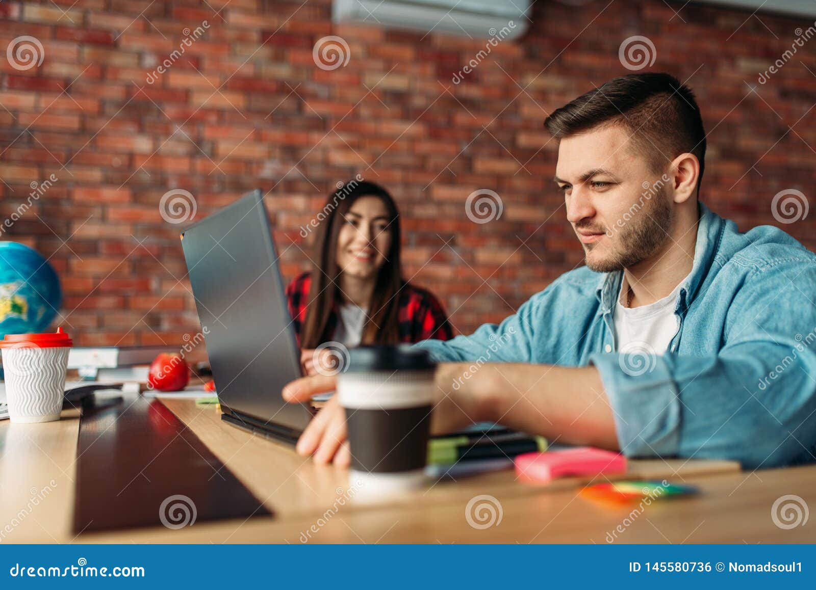 University Students Studying at the Table Together Stock Photo - Image ...