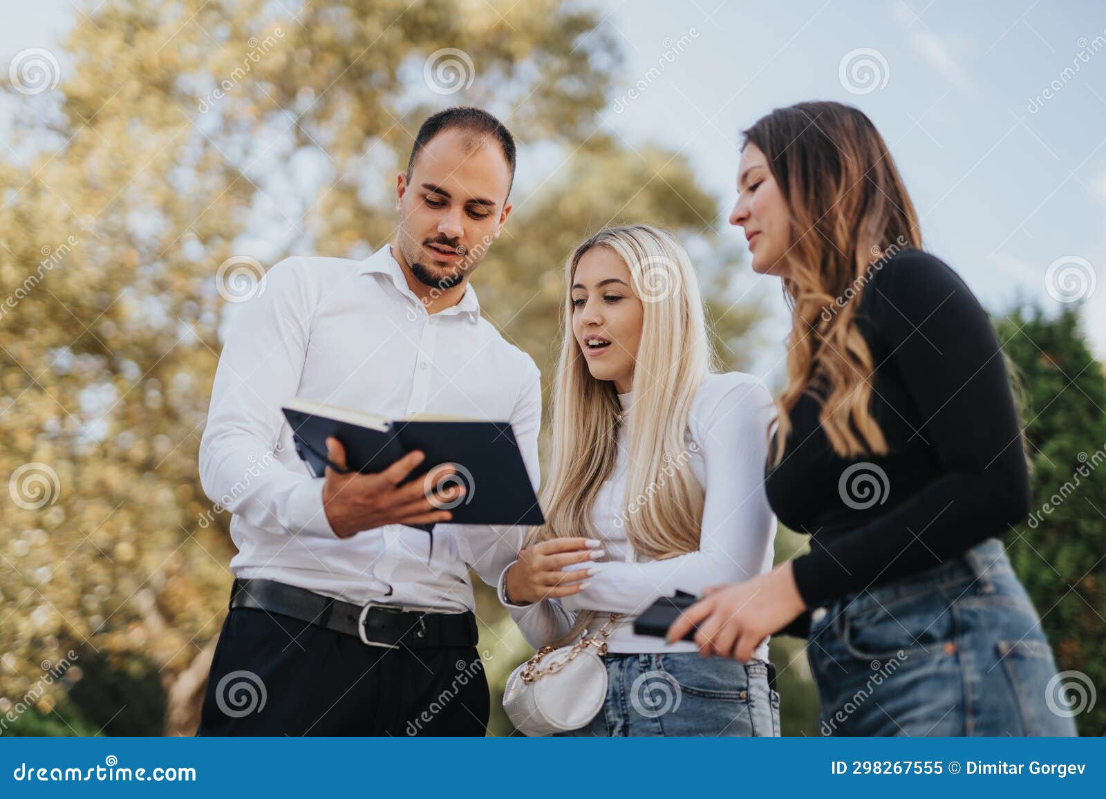 University Students Studying Together Outdoors, Exchanging Knowledge ...