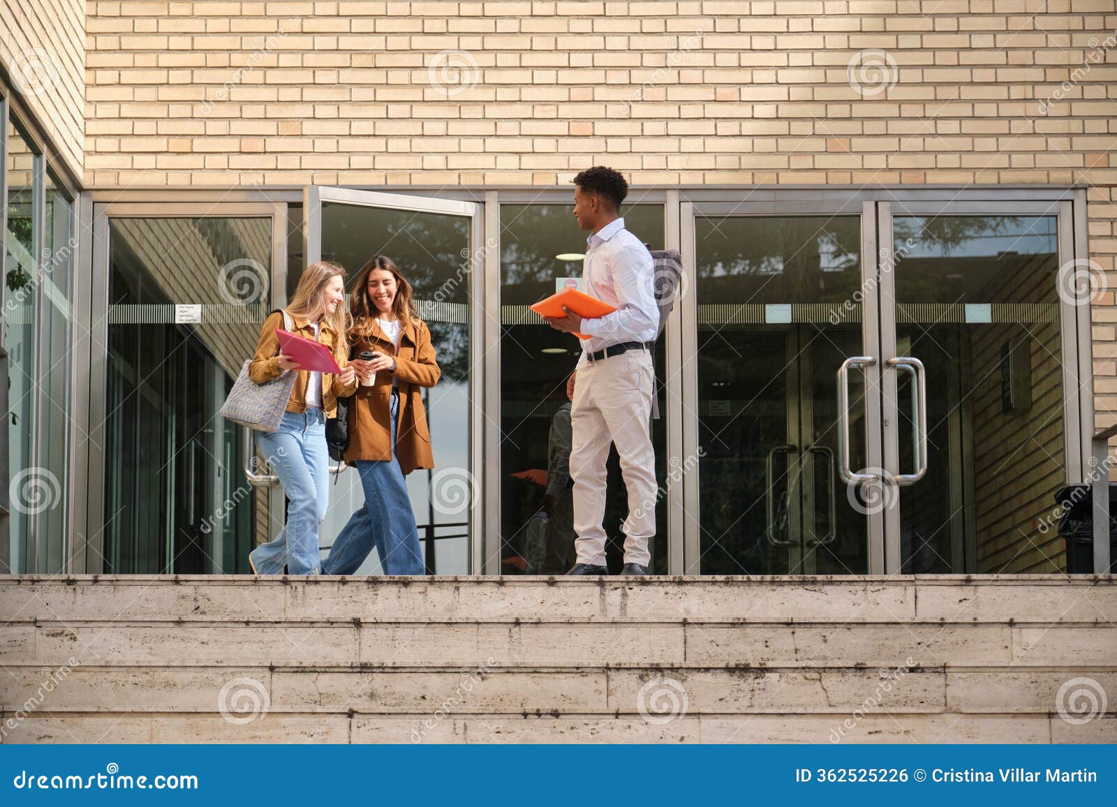 University Students Talking on Steps of Campus Building Stock Photo ...