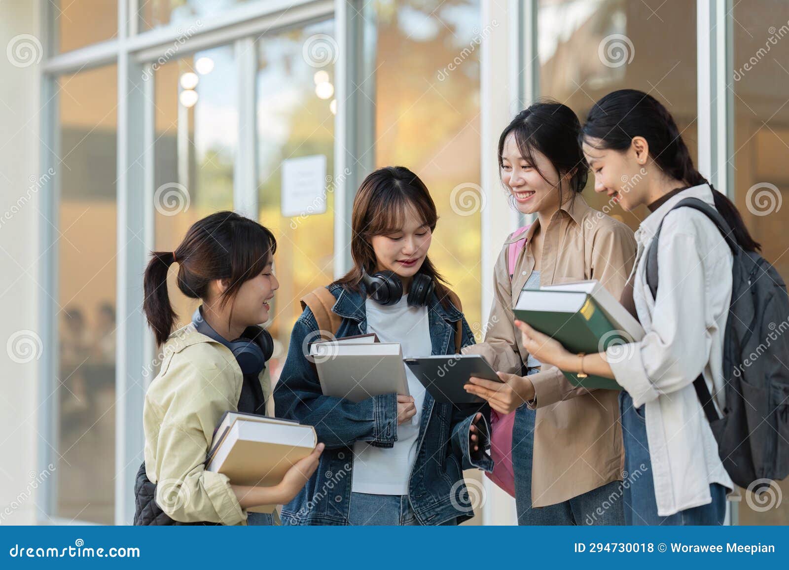 University Students Using a Digital Tablet while Walking To Next Class ...