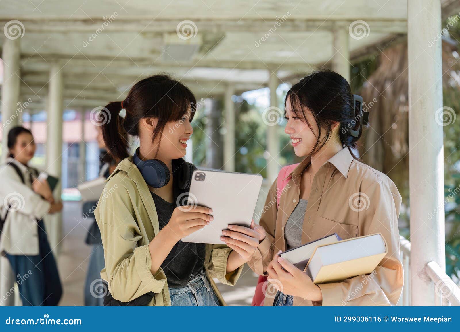 University Students Using a Digital Tablet while Walking To Next Class ...