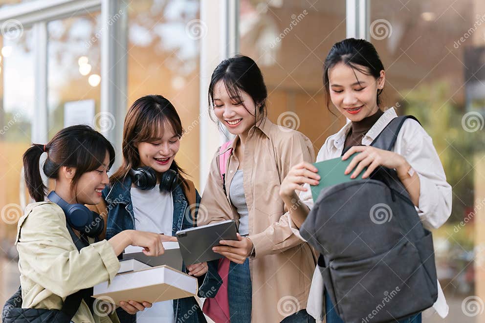 University Students Using a Digital Tablet while Walking To Next Class ...