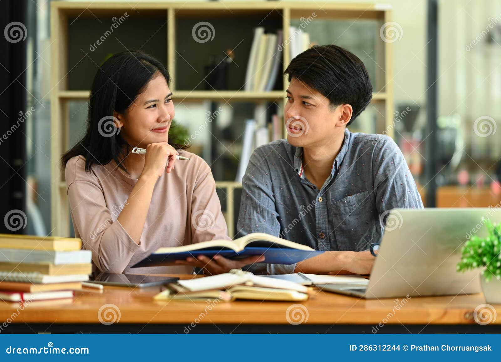 University Students Using Laptop, Working Together on Academic Project ...