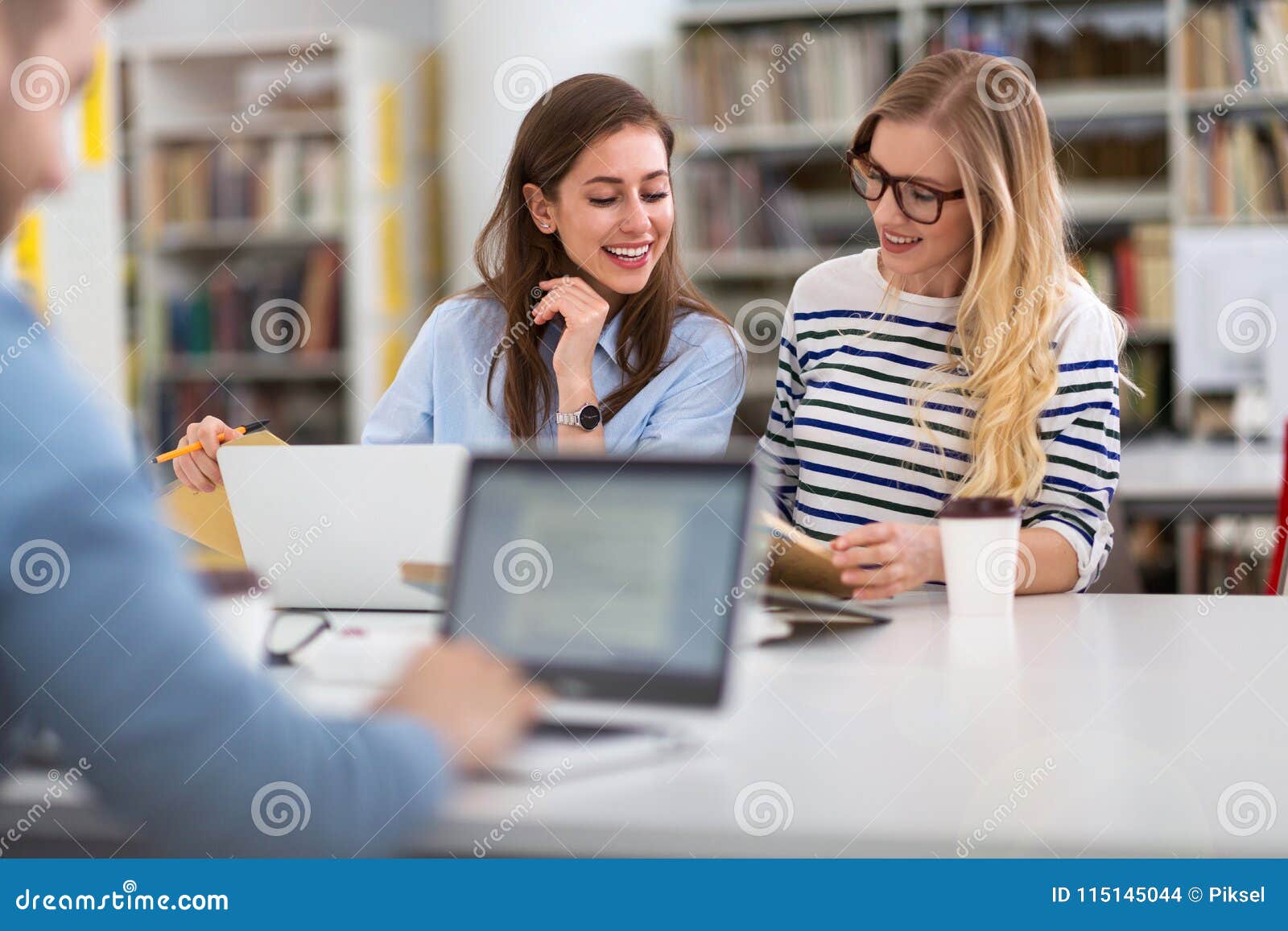 Students Working in the Library at Campus Stock Photo - Image of shelf ...