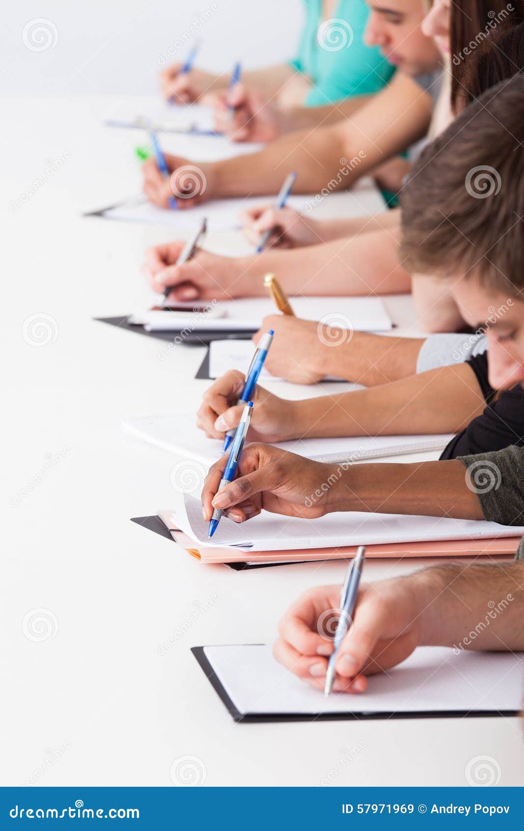 University Students Writing at Desk Stock Image - Image of desk, girl ...