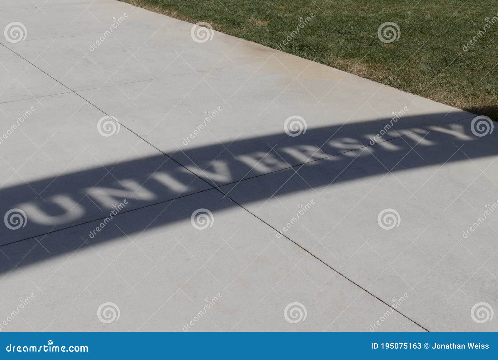 University Text in Shadow on the Ground of a College Campus Stock Image ...