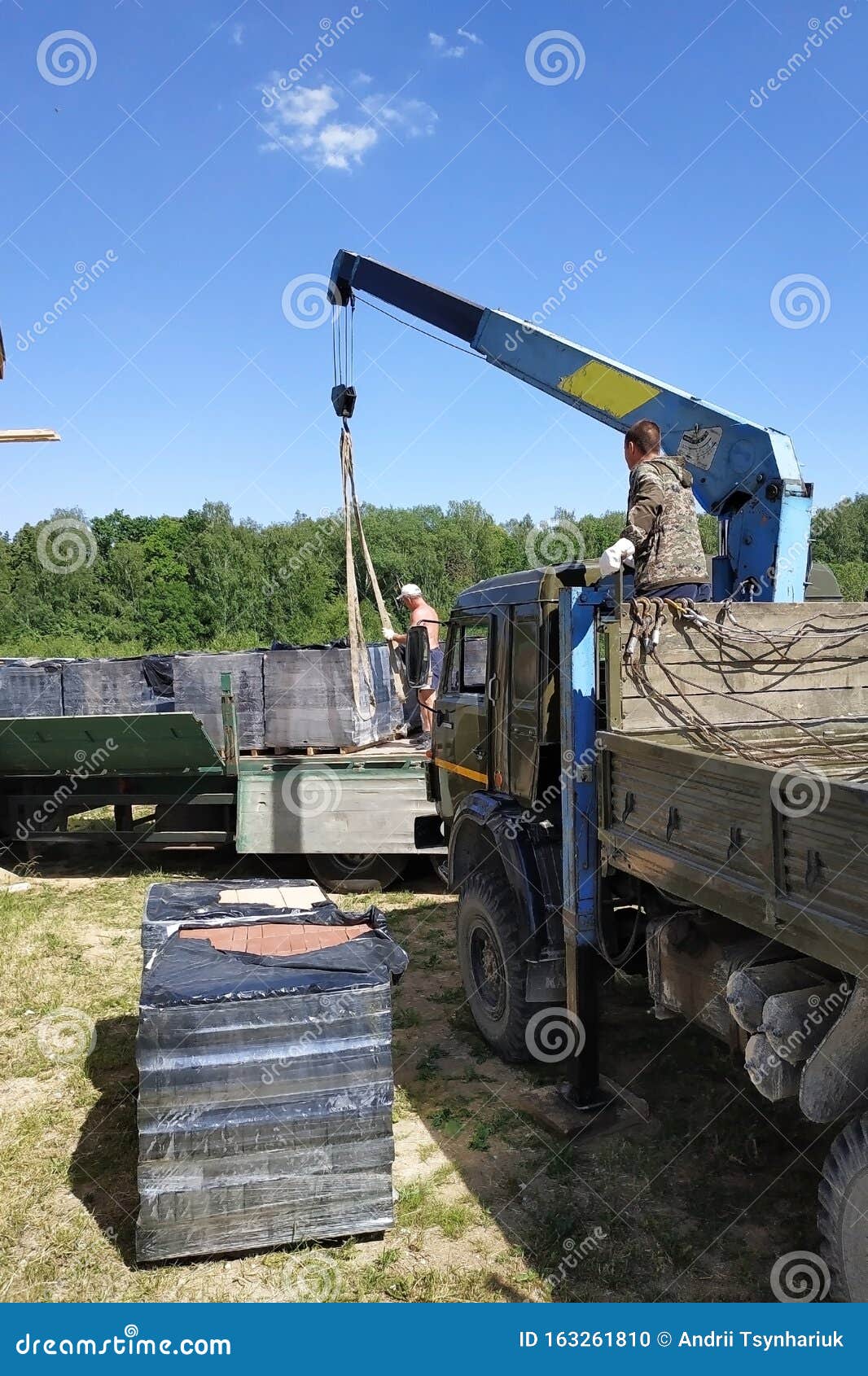 Unloading the Front Brick Using a Mobile Crane in the Village in ...