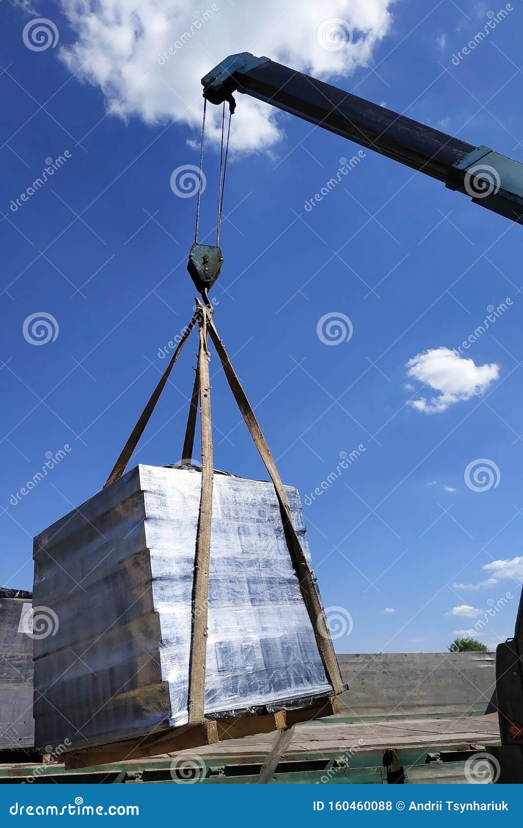 Unloading the Front Brick Using a Mobile Crane in the Village in ...