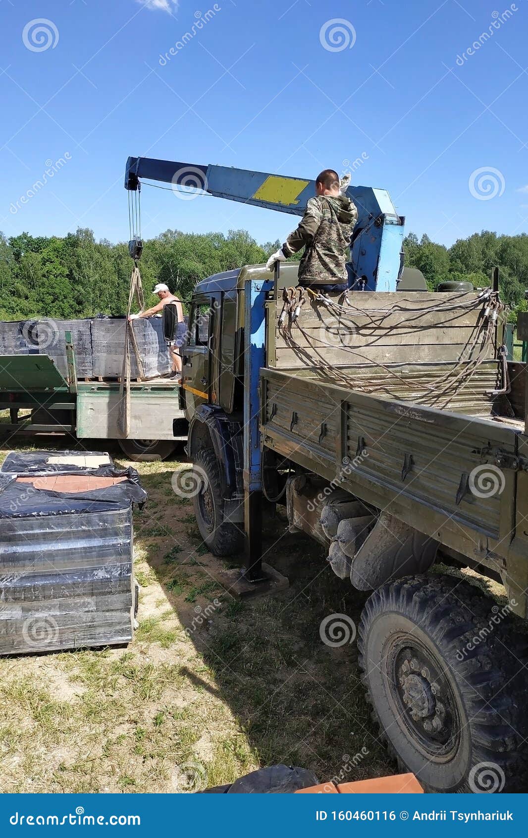Unloading the Front Brick Using a Mobile Crane in the Village in ...
