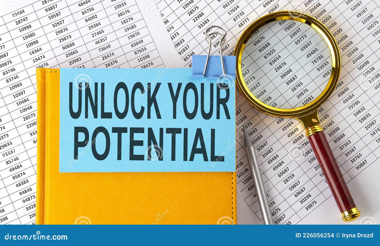 Unlock Your Potential Text on Sticker on Notebook with Magnifier and ...