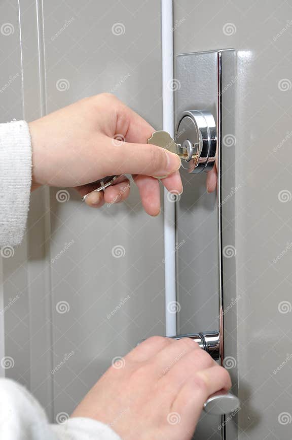 Unlocking the door stock image. Image of closeup, dark - 17670059