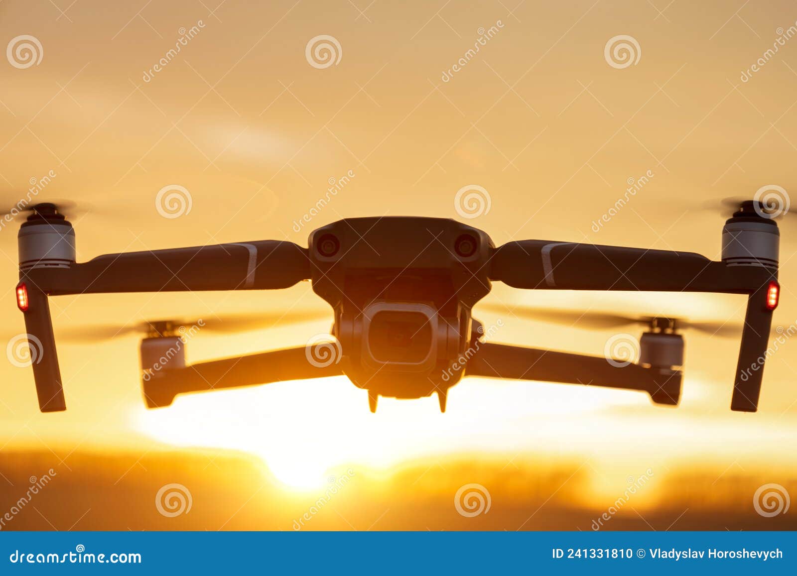 Unmanned Quadcopter in Flight with a Digital Camera at Sunset. Drone ...