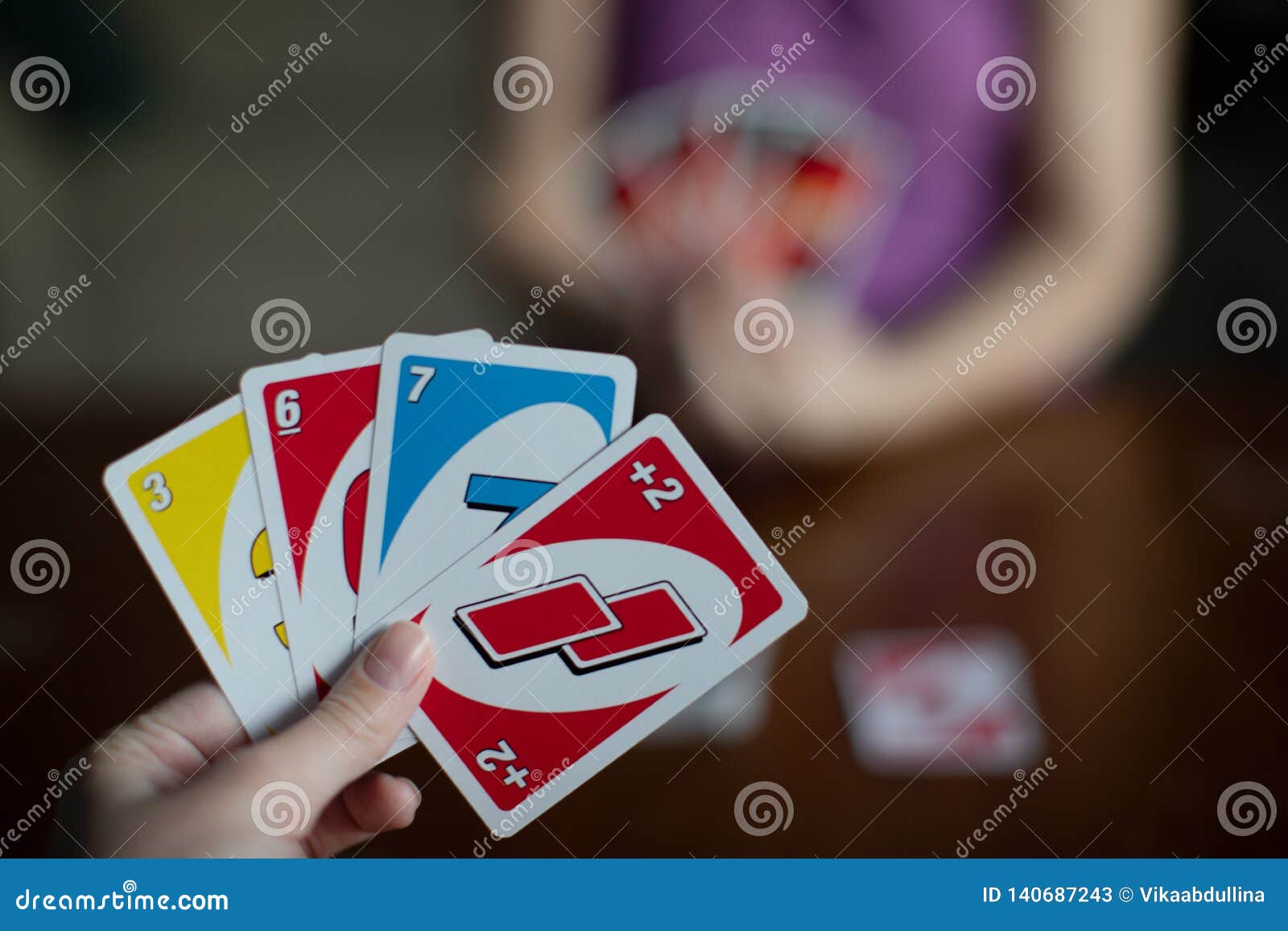 Playing American Card Game Uno, Holding Game Cards in Female Hand ...