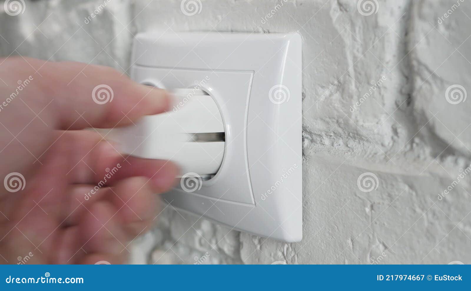 Unplugging an Electrical Power Cord from a Wall Socket in the Office ...