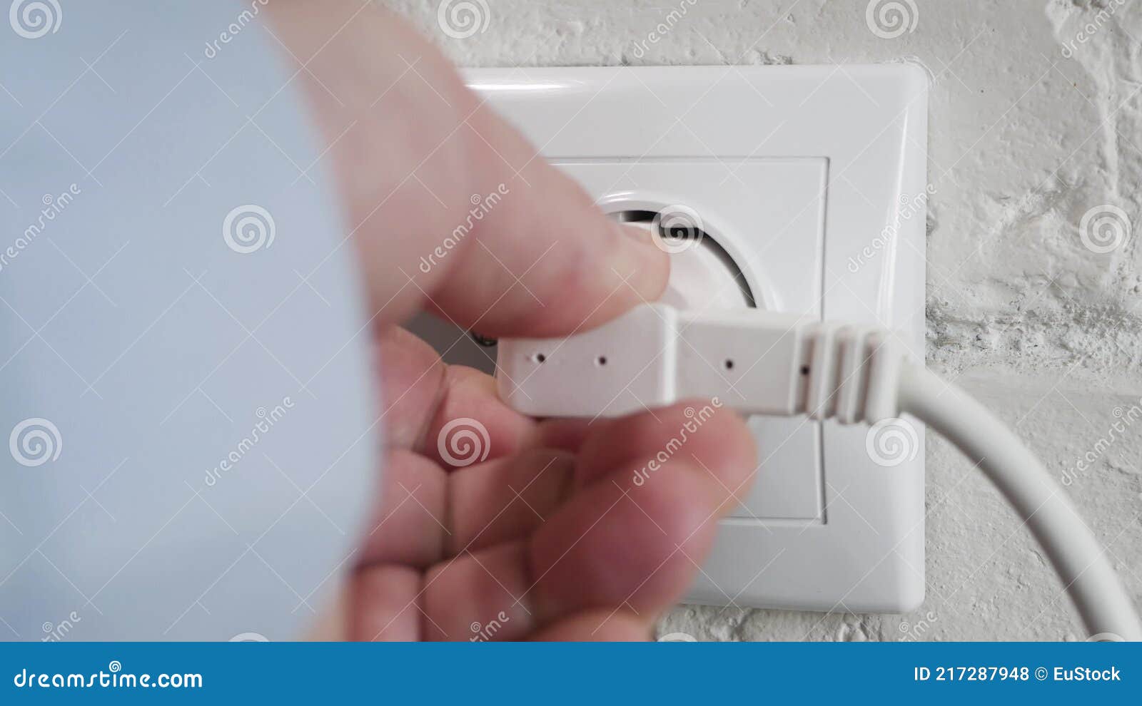 Unplugging an Electrical Power Cord from a Wall Socket in the Office ...