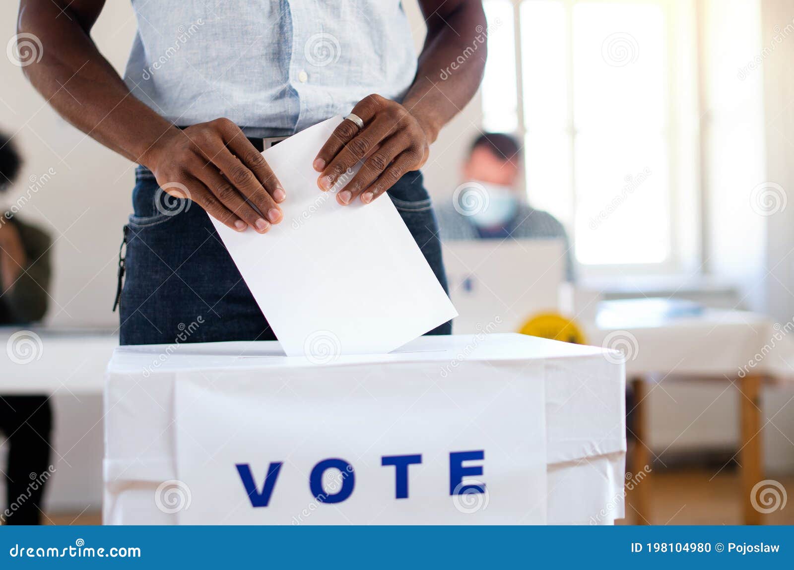 Unrecognizable African-american Man Putting His Vote in the Ballot Box ... Unrecognizable African-american Man Putting His Vote in the Ballot Box ...