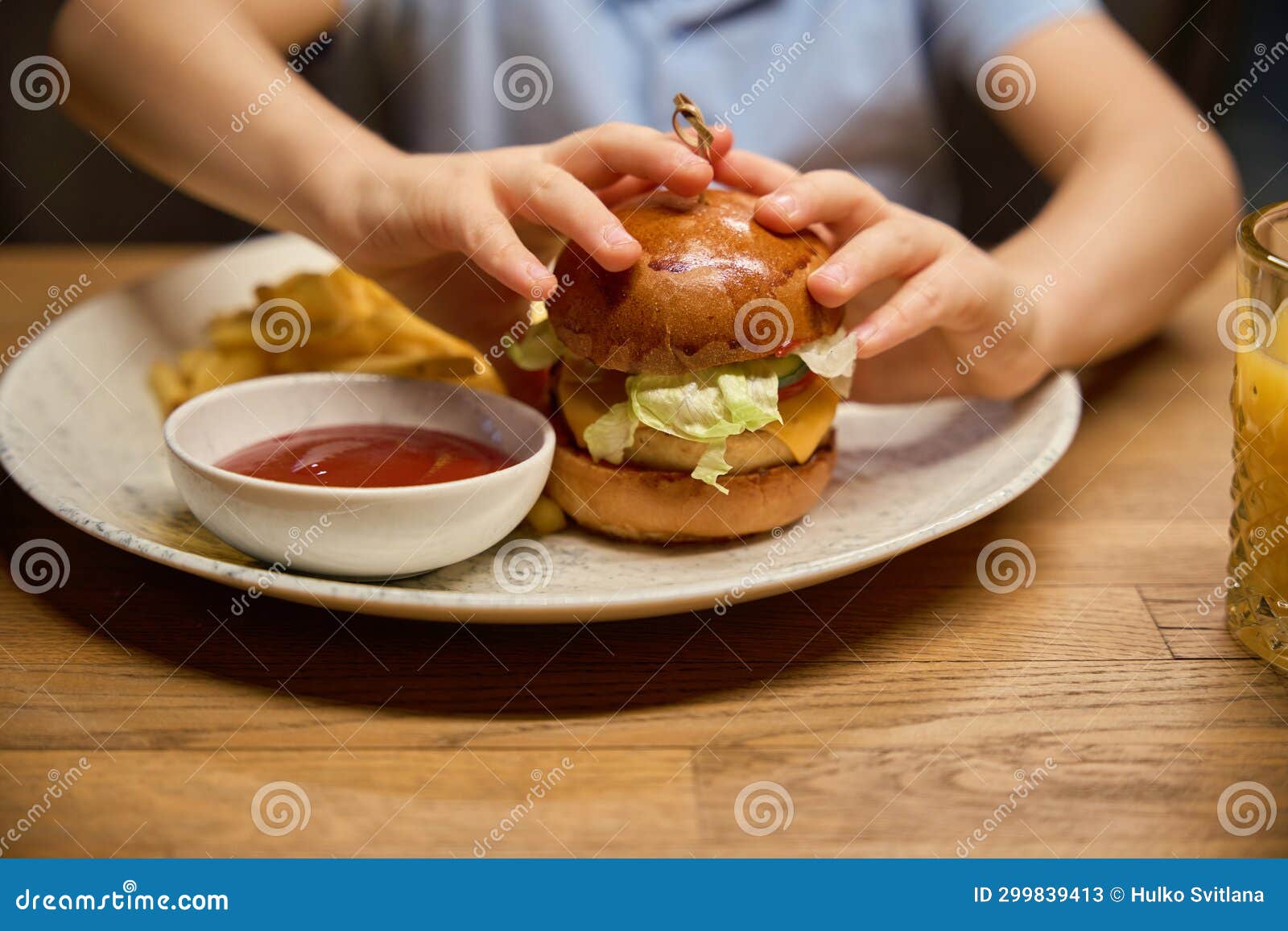 Unrecognizable Child Taking Burger in Restaurant during Winter Holidays ...