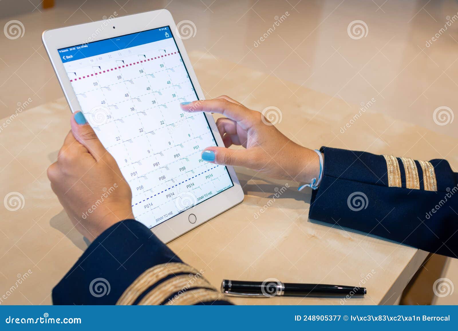 Unrecognizable Female Pilot Preparing Flight Documentation on a Tablet ...