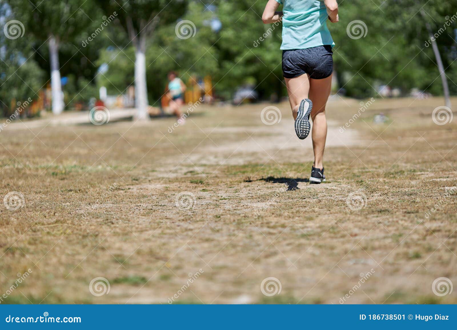 Unrecognizable Girl Running Around the Field. Back View. No Face Stock ...