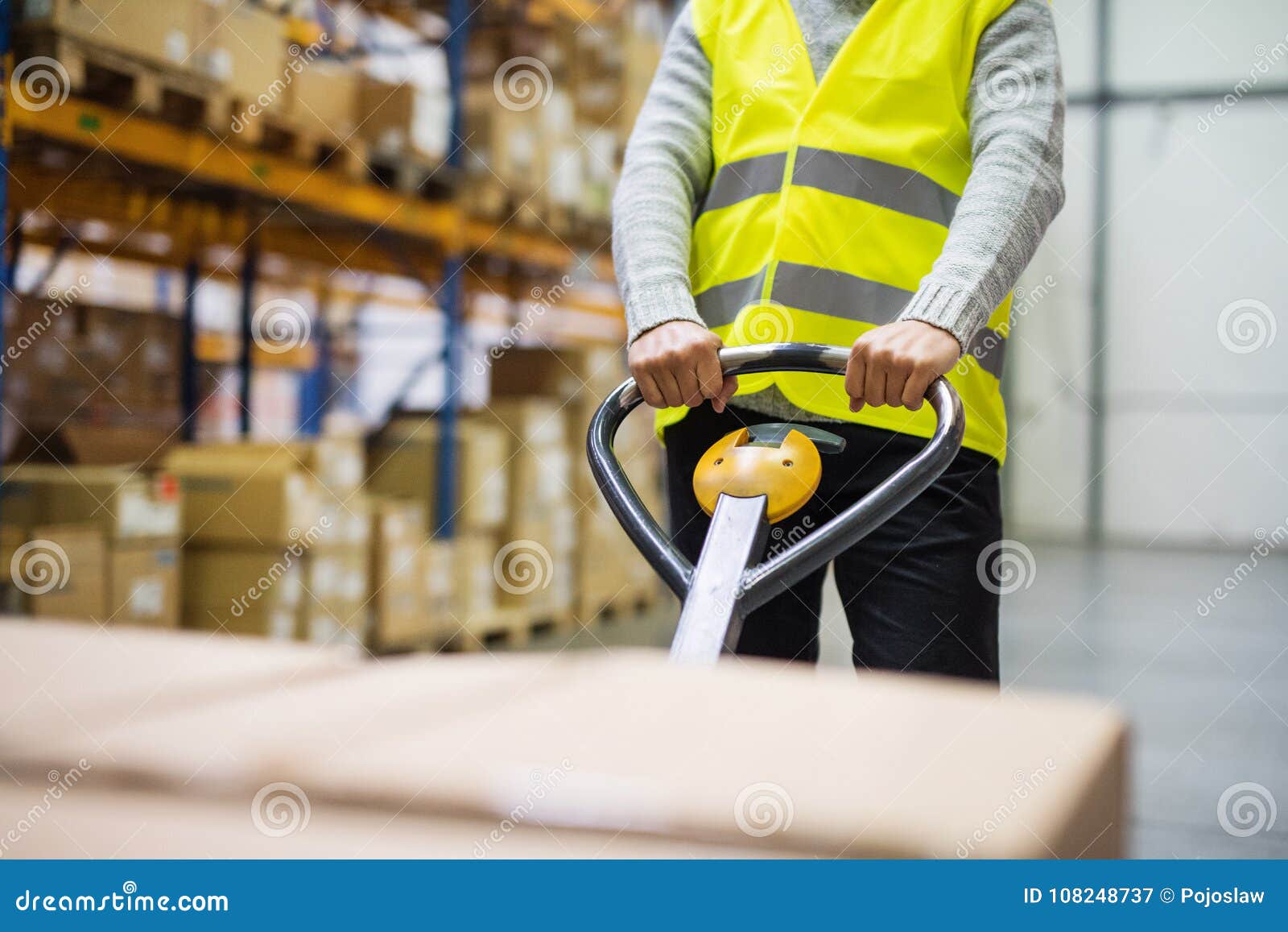 Male Warehouse Worker Pulling a Pallet Truck. Stock Image - Image of ...