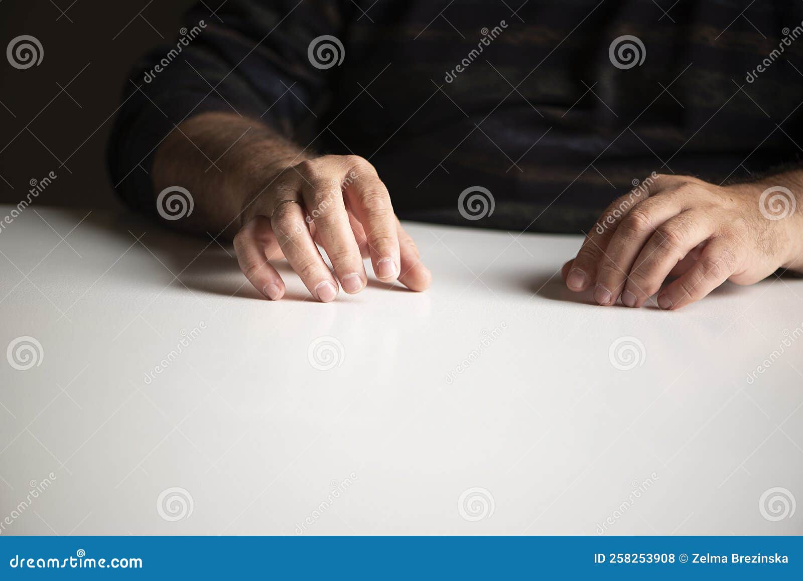 Unrecognizable Man in a Familiar Position Sitting at a White Empty ...