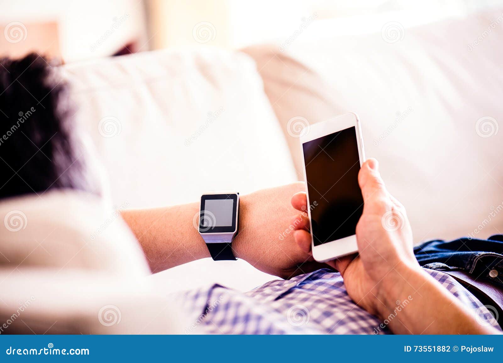 Unrecognizable Man at Home Using Smartphone and Smart Watch Stock Photo ... Unrecognizable Man at Home Using Smartphone and Smart Watch Stock Photo ...