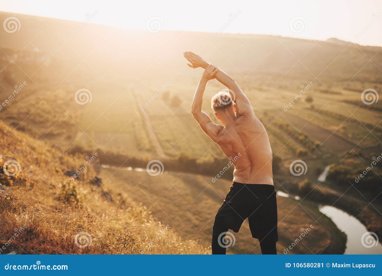 Man Stretching Back on Hill Stock Image - Image of muscle, male: 106580281