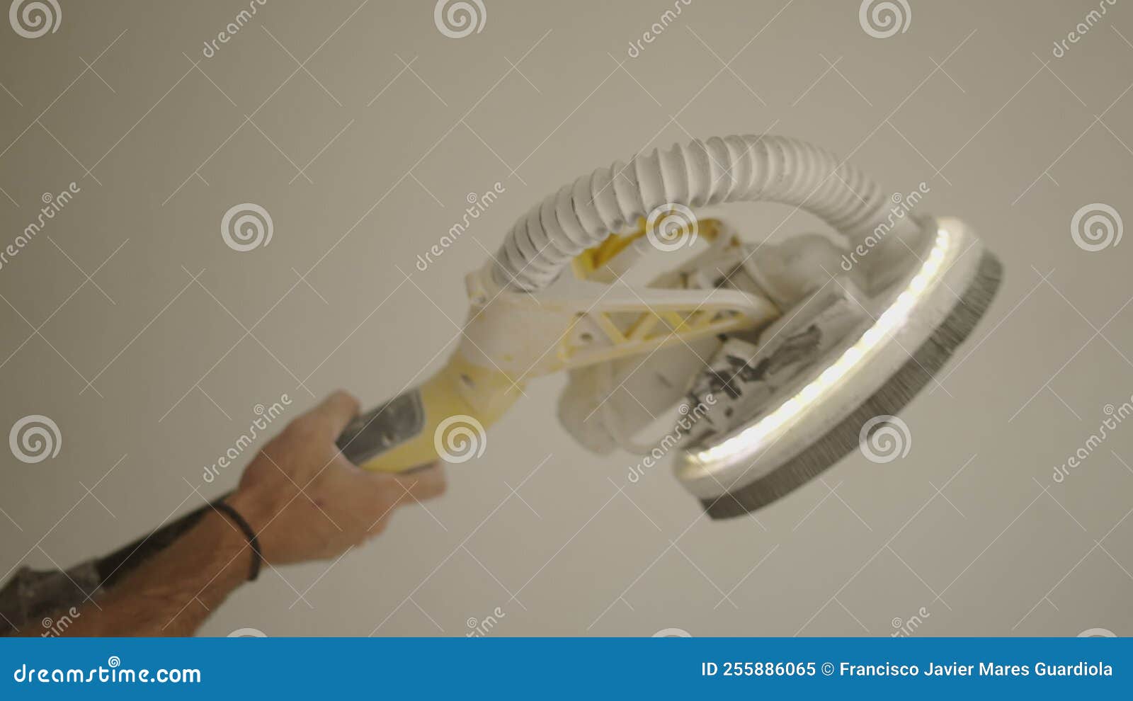 Unrecognizable Man Turns on Sanding Machine and Smooths Wall Stock ...