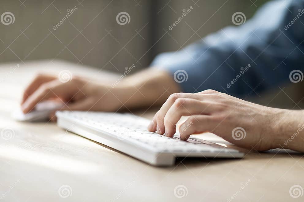 Unrecognizable Man Typing On Computer Keyboard And Using Wireless Mouse