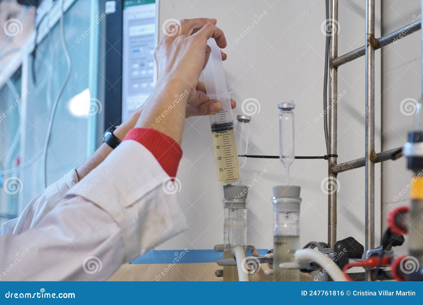 Unrecognizable Researcher Taking Sample from a Reactor in a Laboratory ...