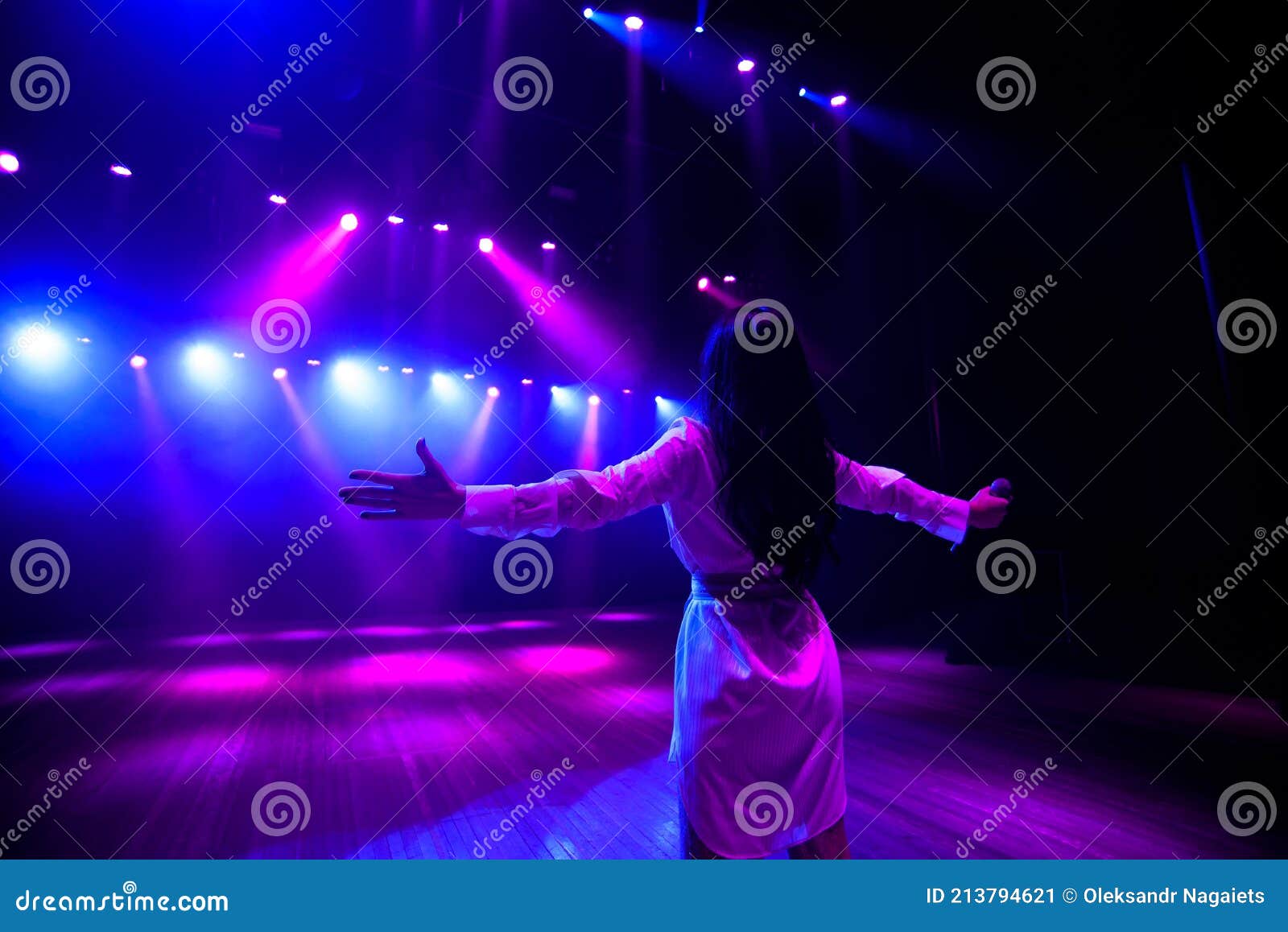 Unrecognizable Singer Standing on Stage at Microphone, Back View, Neon ...