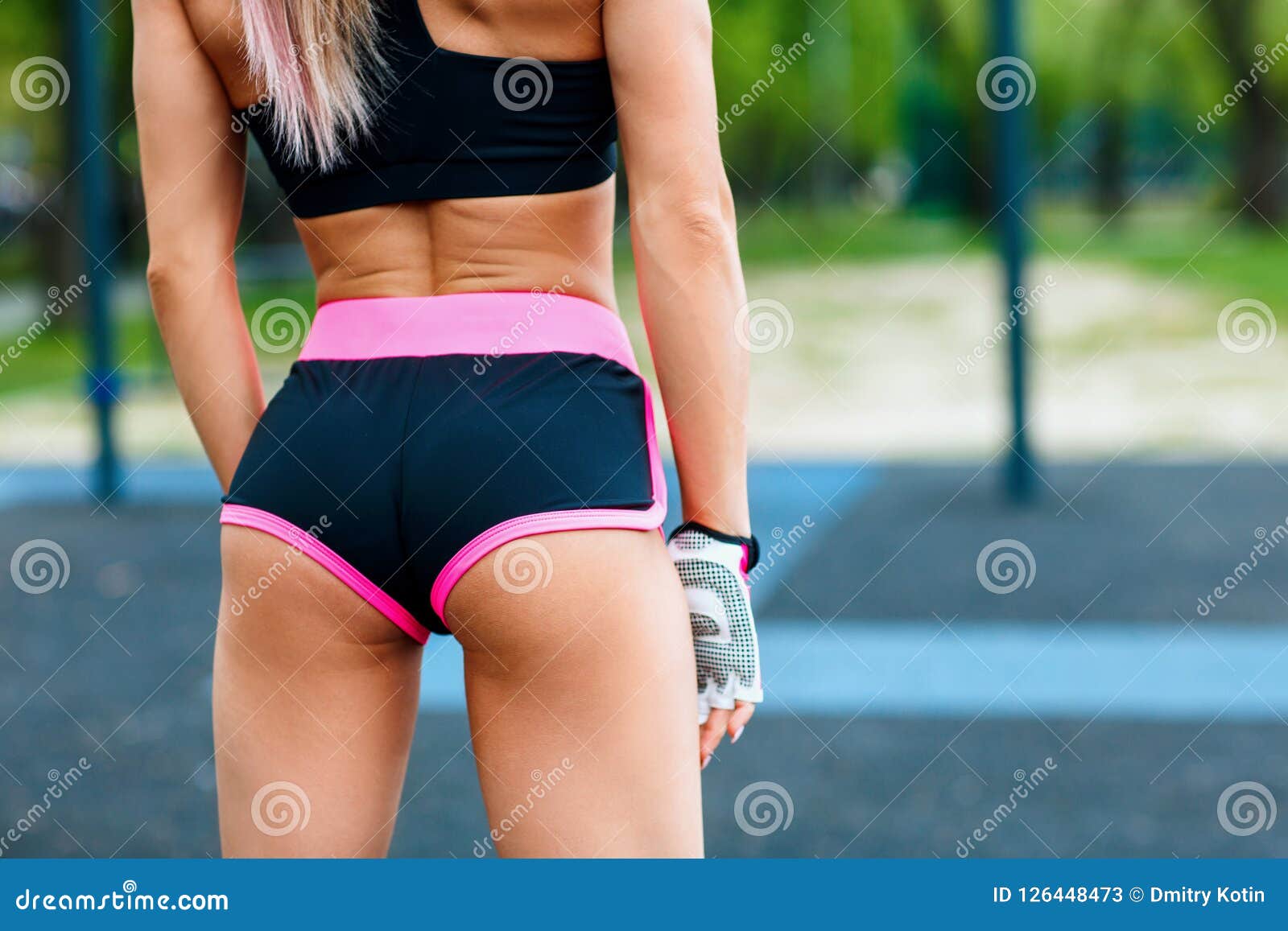 Sporty Woman In Bright Sportswear Posing On Sports Ground Stock Image