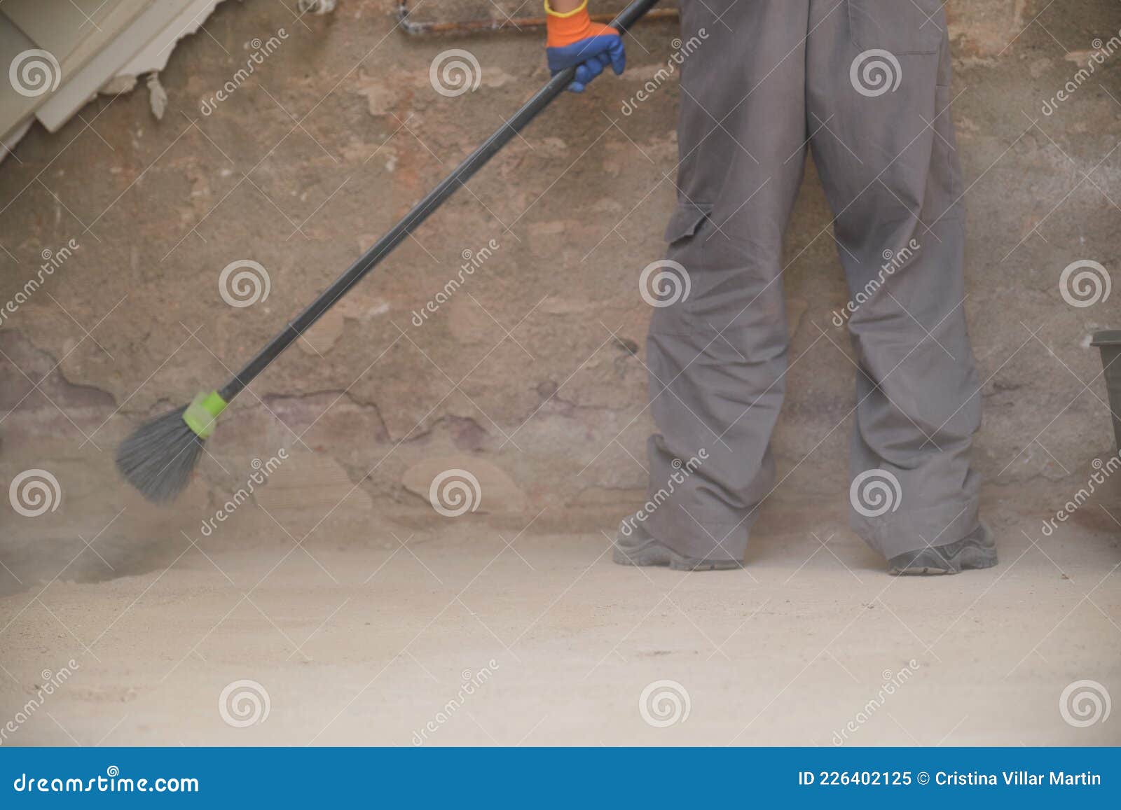 Unrecognizable Young Builder Sweeping the Floor at a Construction Site ...