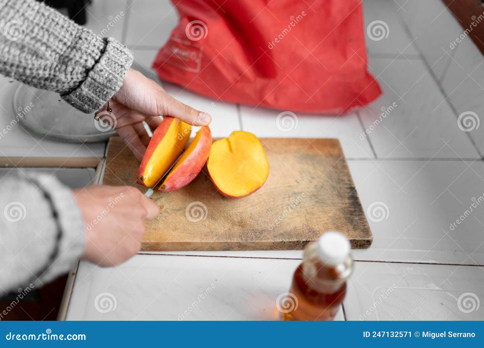 Unrecognizable Young Man is Chopping a Mango on the Cutting Board for ...