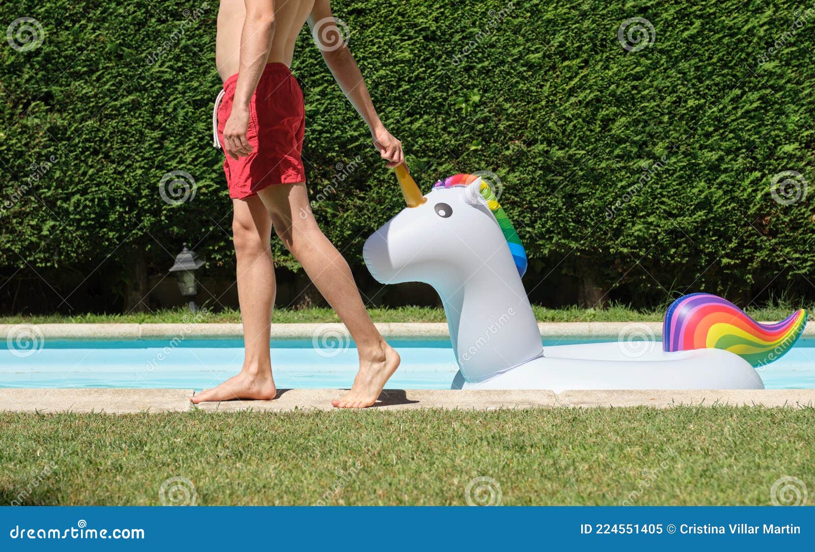 Unrecognizable Young Man Walking a Big Unicorn Inflatable Ring at a ... Unrecognizable Young Man Walking a Big Unicorn Inflatable Ring at a ...
