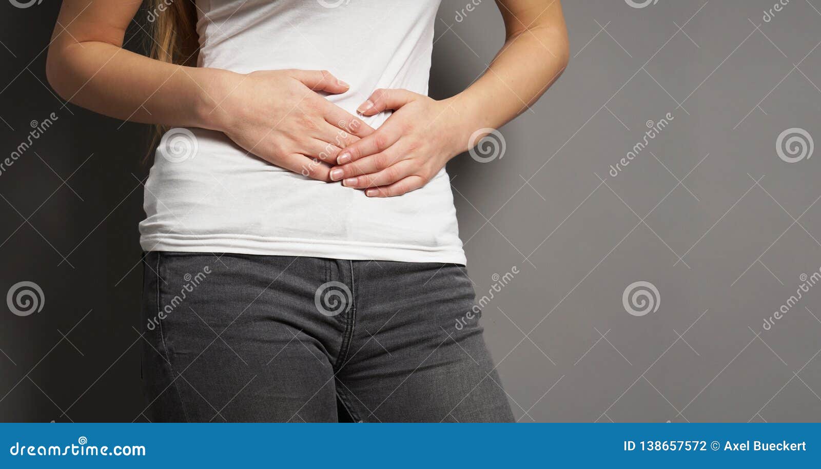 Unrecognizable Young Woman Holding Her Stomach With Both Hands