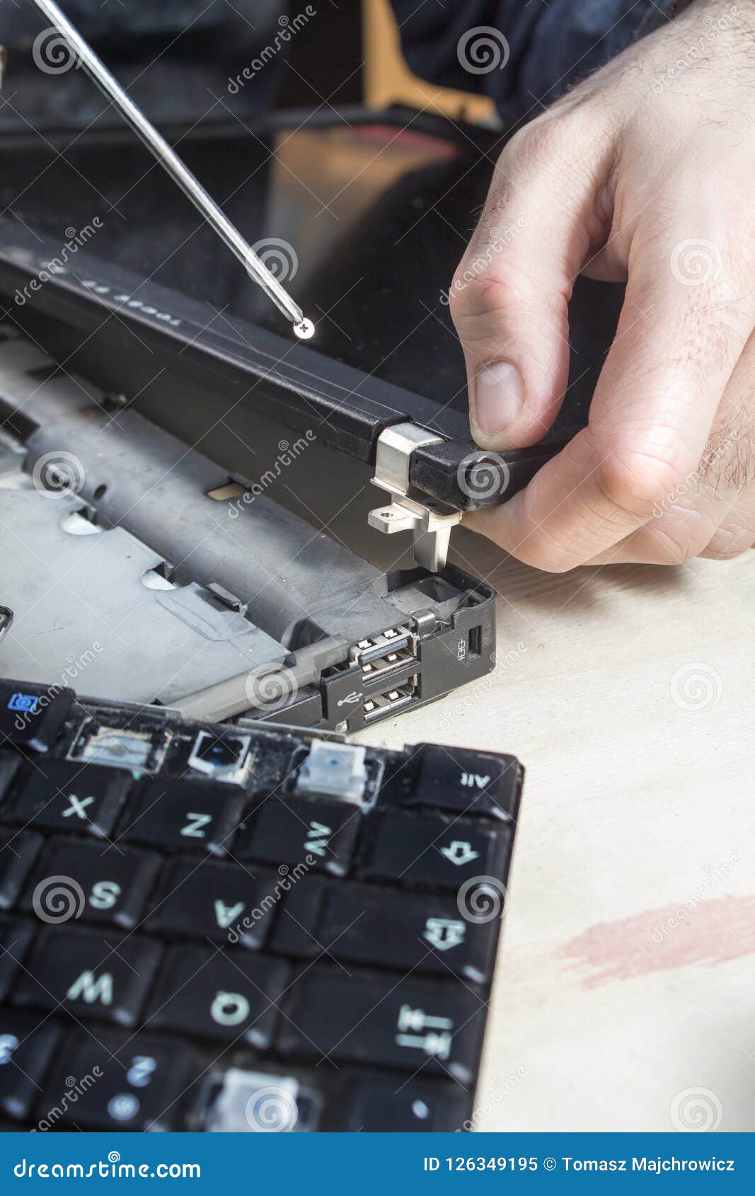 Unscrewing the Hinge Bolt on the Laptop Screen on the Computer Service ...