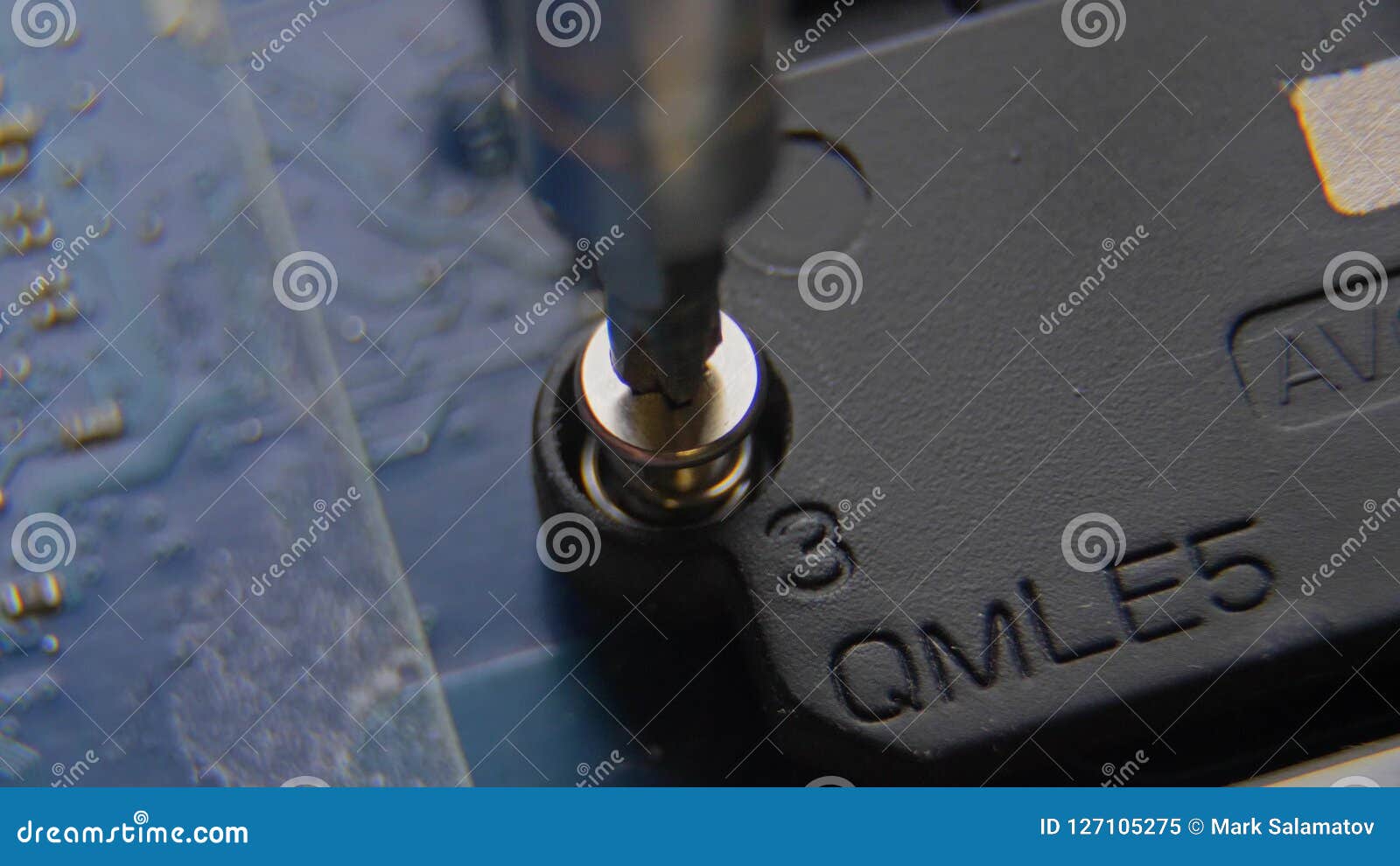 Unscrewing the Screw. a Hand Holding a Screwdriver is Installing or ...